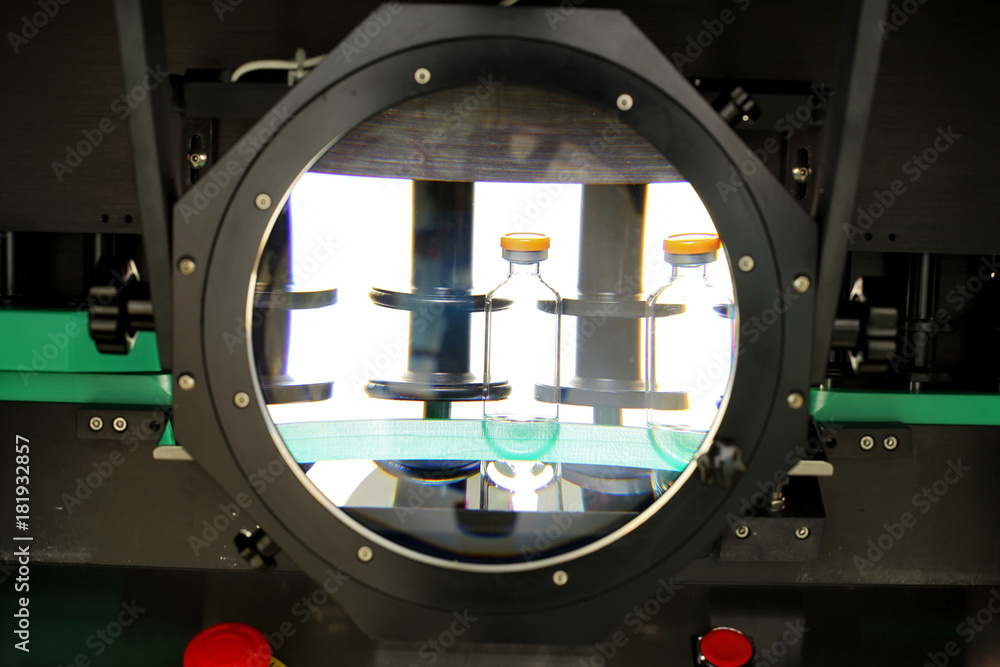 Quality Control vials for injection. Individual checks vial under a ...