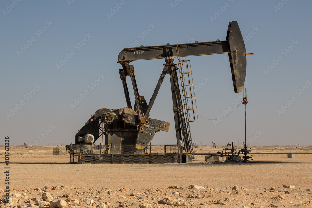 Crude oil drilling well pumping the black gold out of the soil on an ...