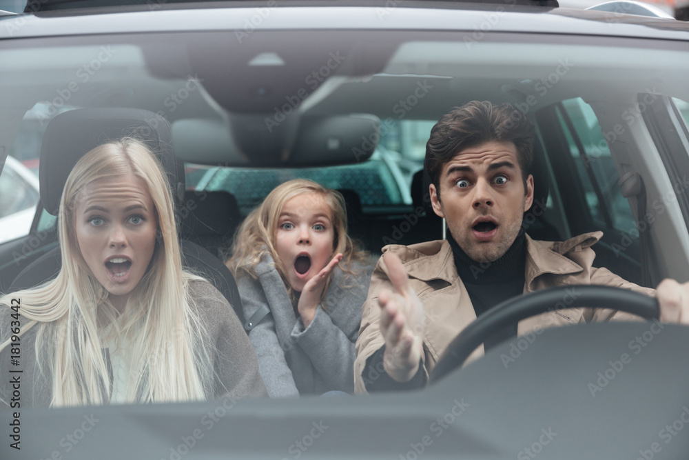 Shocked scared young man sitting in car with family Stock Photo | Adobe ...
