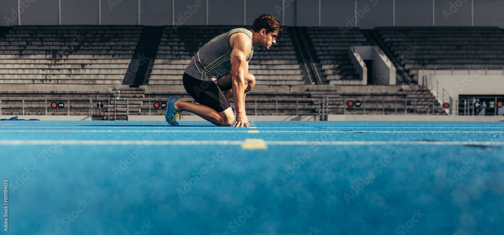Sprinter on his marks on a running track Stock Photo | Adobe Stock