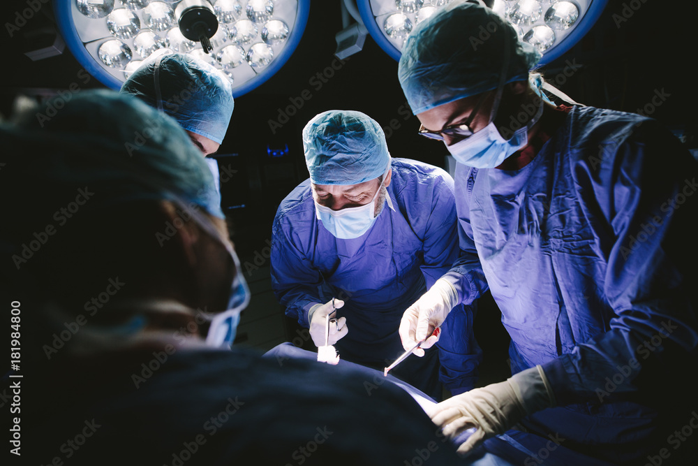 Team of professional surgeons performing surgery Stock Photo | Adobe Stock
