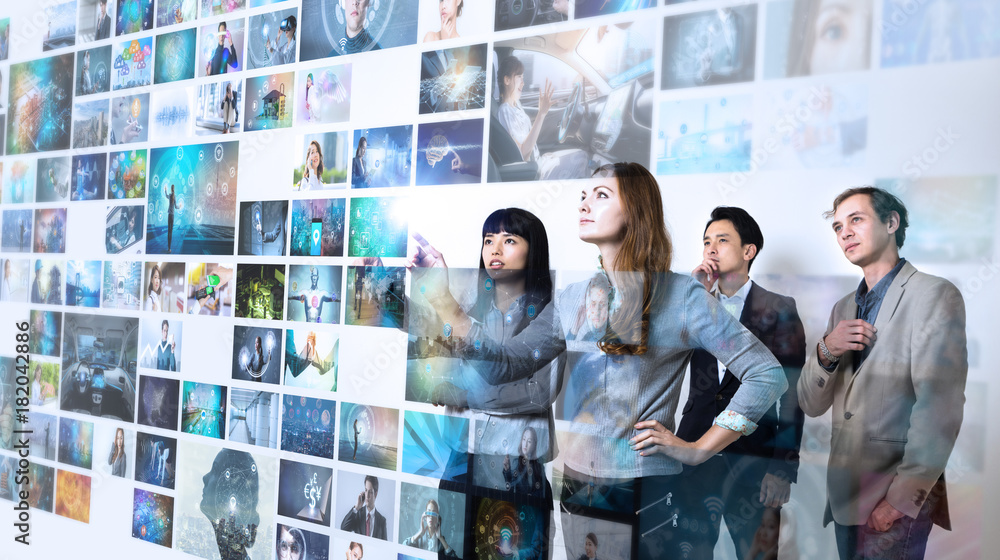 Group of people watching at a lot of pictures. Internet of Things ...