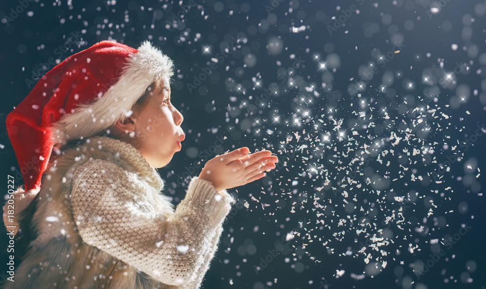 girl blowing on snow Stock Photo | Adobe Stock