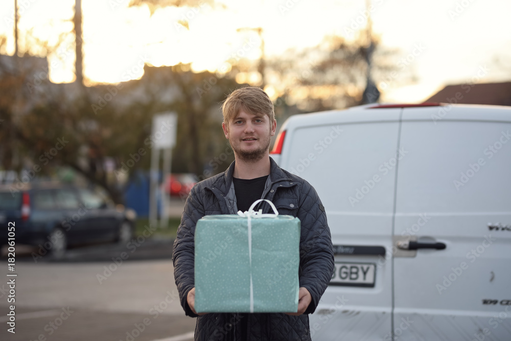Courier delivery guy service transport gift box outside near his van ...