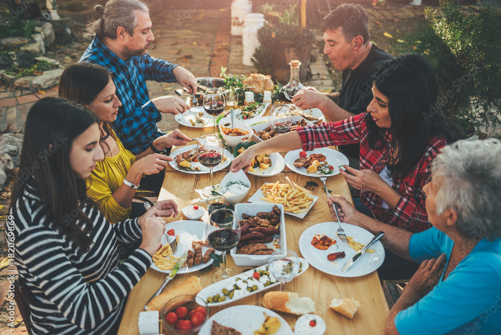 Family dining outdoors Stock Photo | Adobe Stock