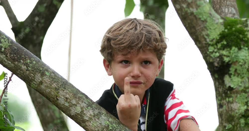 Young infant boy gives the middle finger while in tears. Infant boy ...
