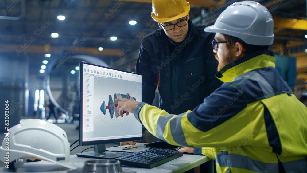 Inside the Heavy Industry Engineer Works on the Personal Computer while ...