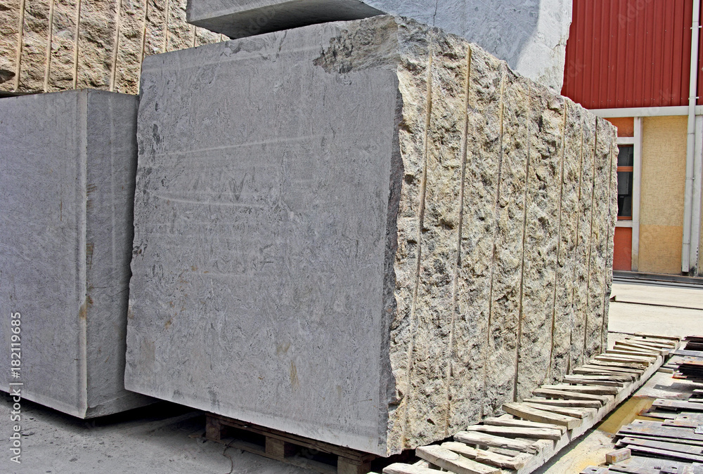 Close up of huge natural granite stone blocks ready for processing by ...