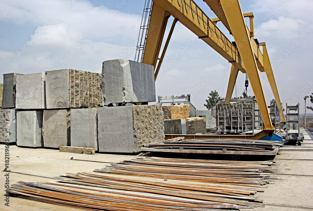 Heavy natural granite stone blocks stacked for processing into floor ...
