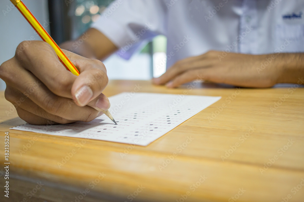 Uniform School Asian students taking exams writing answer optical form ...