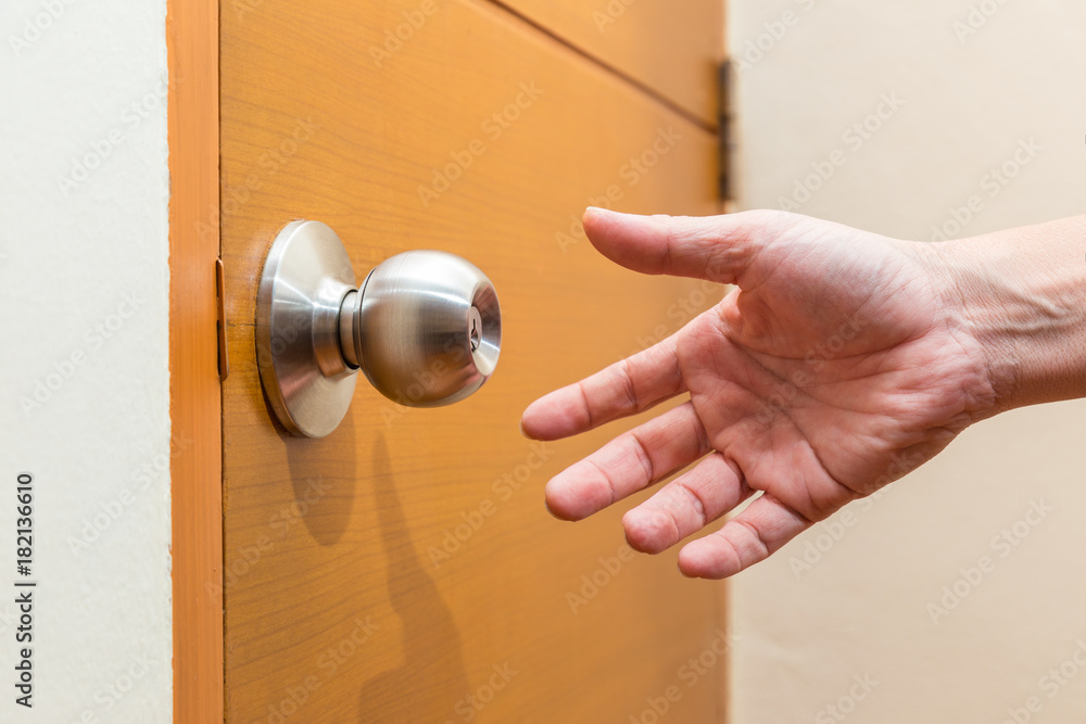 male hand reaching out to grab a door knob Stock Photo | Adobe Stock
