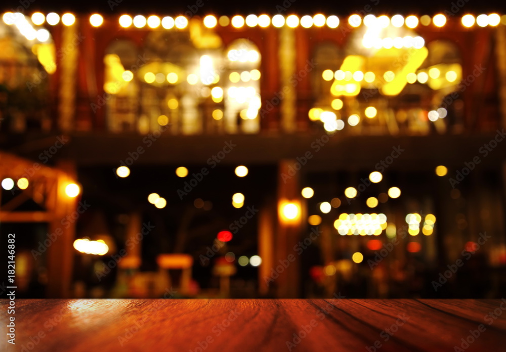 top of wood table with lamp light of bar or night club party background ...