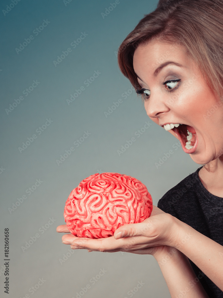 Crazy woman holding brain wanting to eat it Stock Photo | Adobe Stock