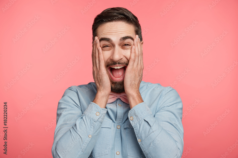 Funny overjoyed glad cheerful bearded male dressed formally, laughs at ...