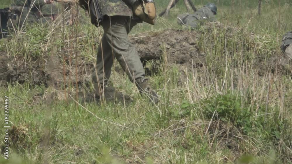 Historical reconstruction of Second World War. Soldiers on battle field ...