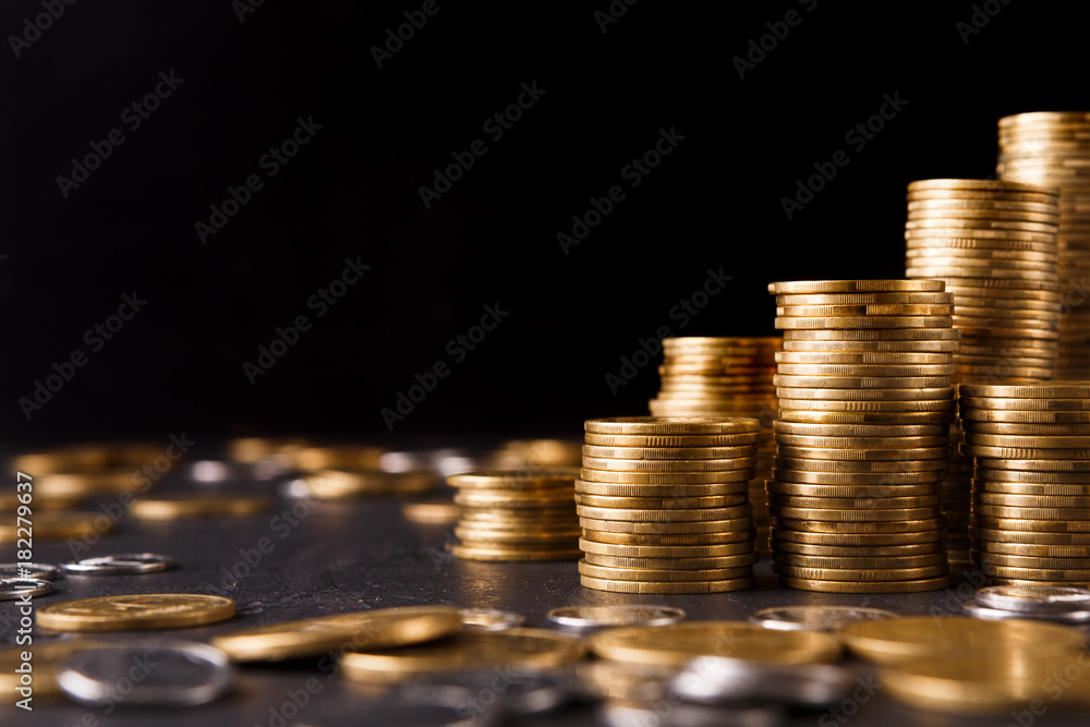 Increasing columns of gold coins on table Stock Photo | Adobe Stock