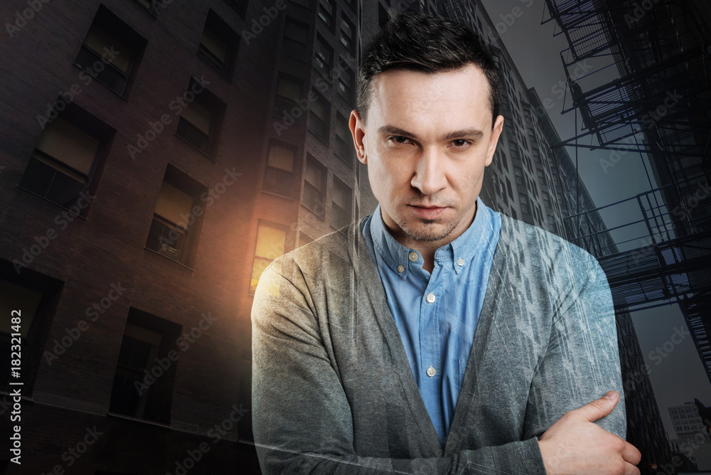 How did you dare. Grumpy millennial guy standing with his arms crossed ...