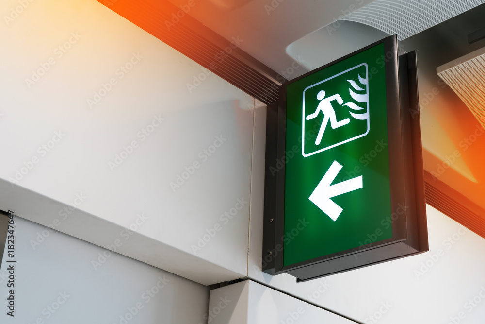Fire exit sign lightbox in the airport terminal emergency exit way ...