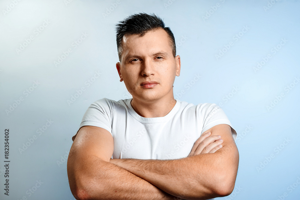 Portrait of a man on a light background close-up. Emotion is the ...