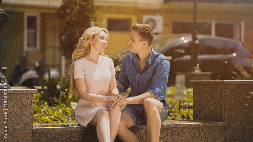 Young man and woman smiling and looking at each other with love ...