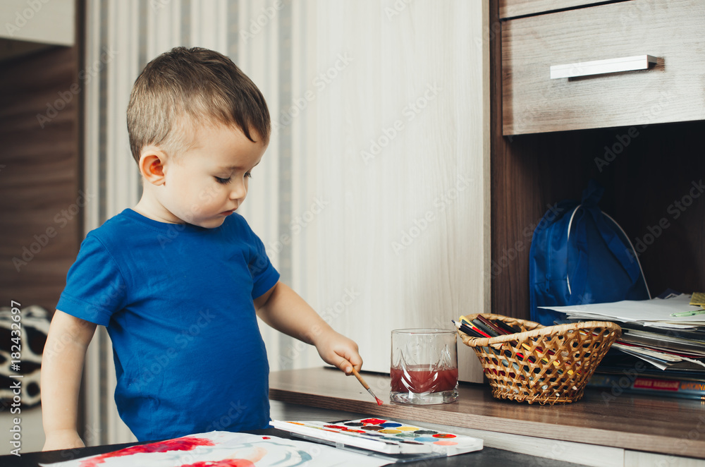the baby in the nursery, with enthusiasm draws paints Stock Photo ...