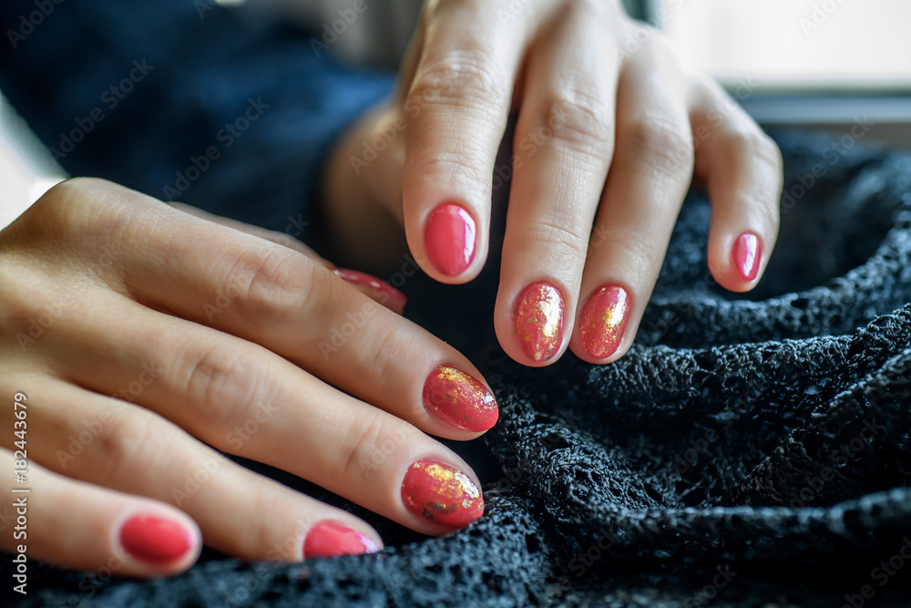 Woman With Beautiful Manicured Red Fingernails Gracefully Crossing Her