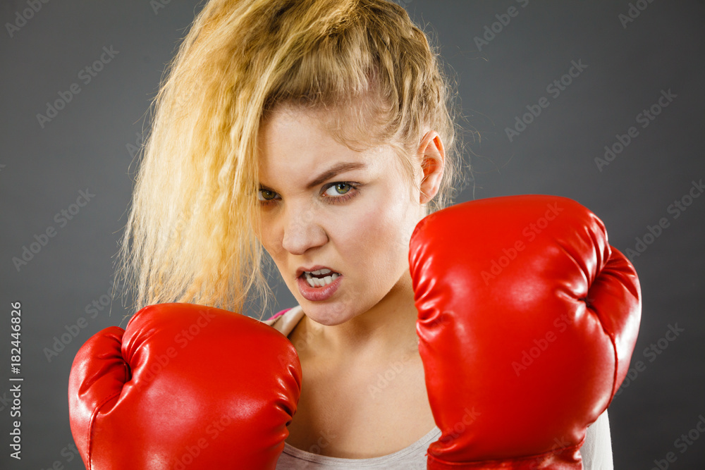 Angry woman wearing boxing gloves Stock Photo | Adobe Stock