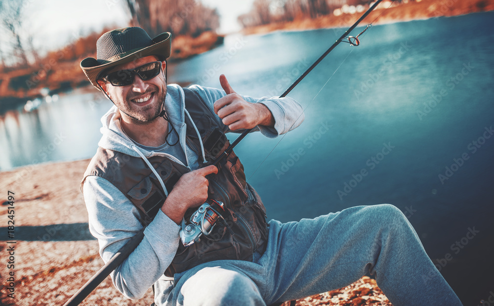 Angler enjoys in fishing on the river. Sport, recreation, lifestyle ...