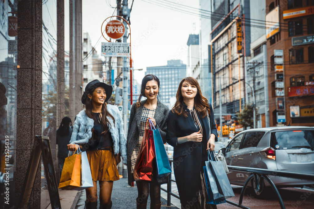 Group of japanese women spending time in Tokyo, making shopping in ...