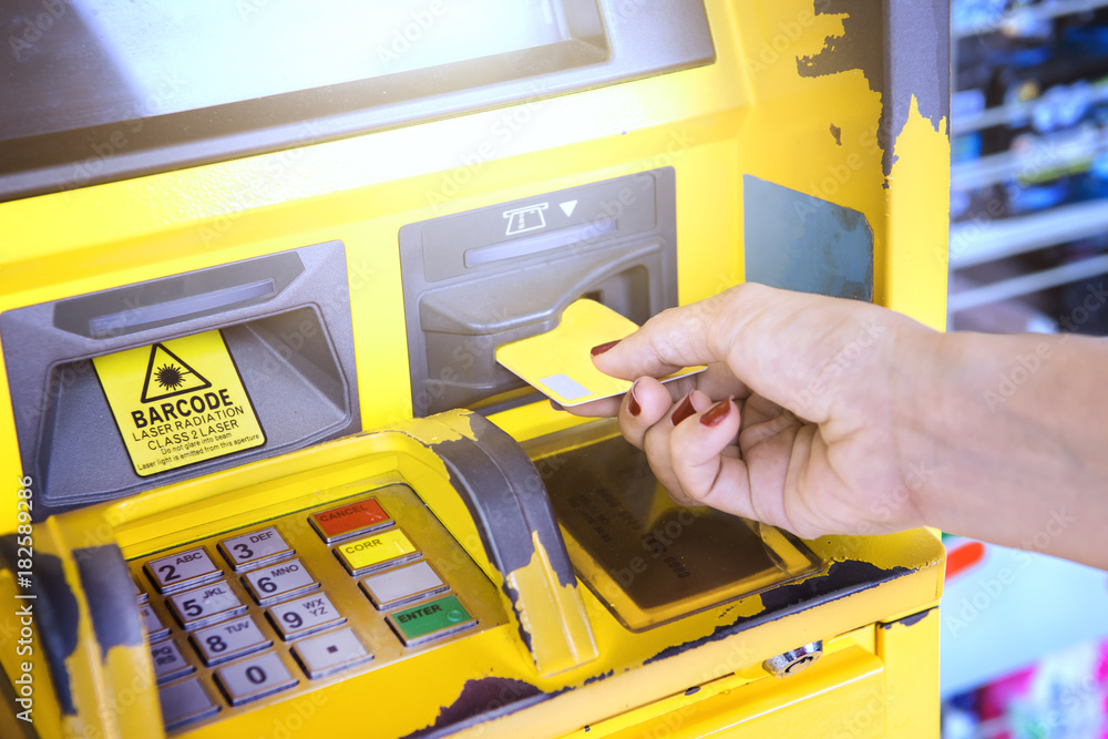 Hand inserting ATM card into bank machine for withdraw money Stock ...