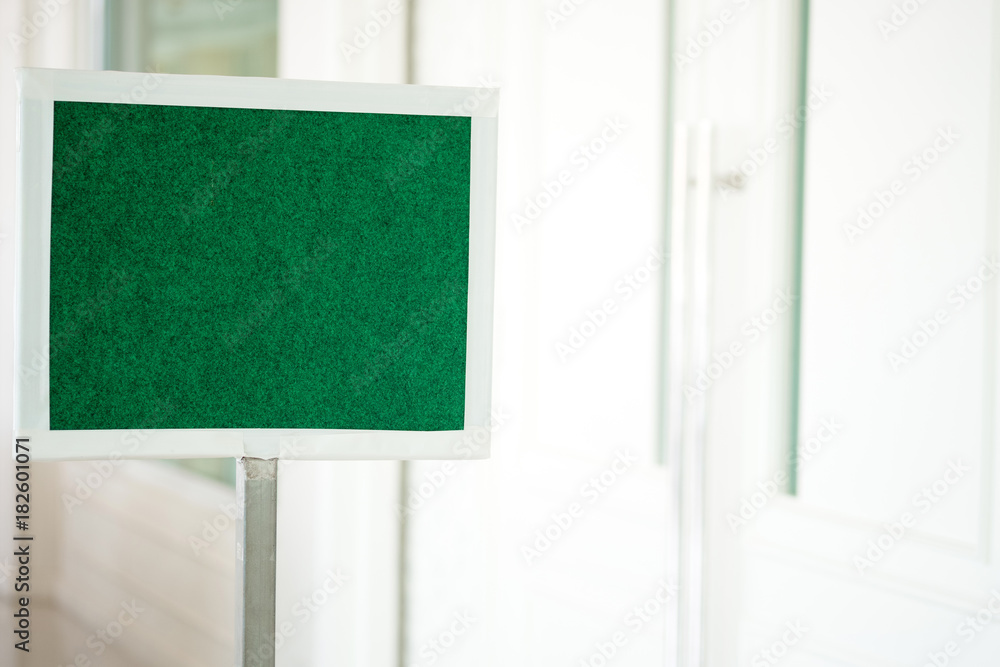 Blank green synthetic fabric billboard or banner standing in front of ...