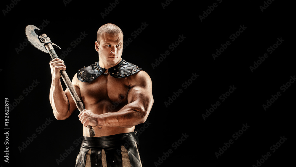 Severe barbarian in leather costume with axe. Studio shot. Black ...