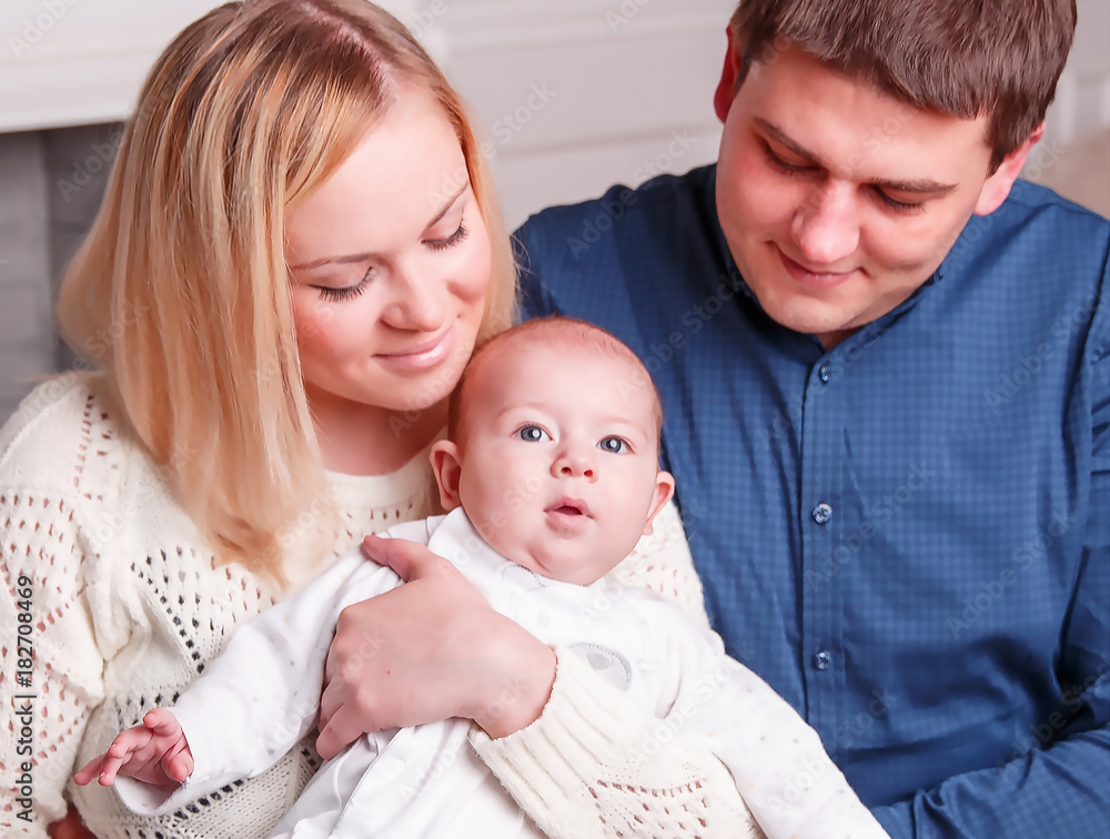 portrait of a happy family: mother,father and year-old child in the ...
