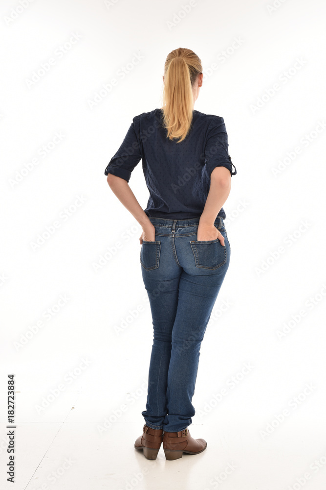 Foto de Full length portrait of a girl wearing simple blue shirt and ...