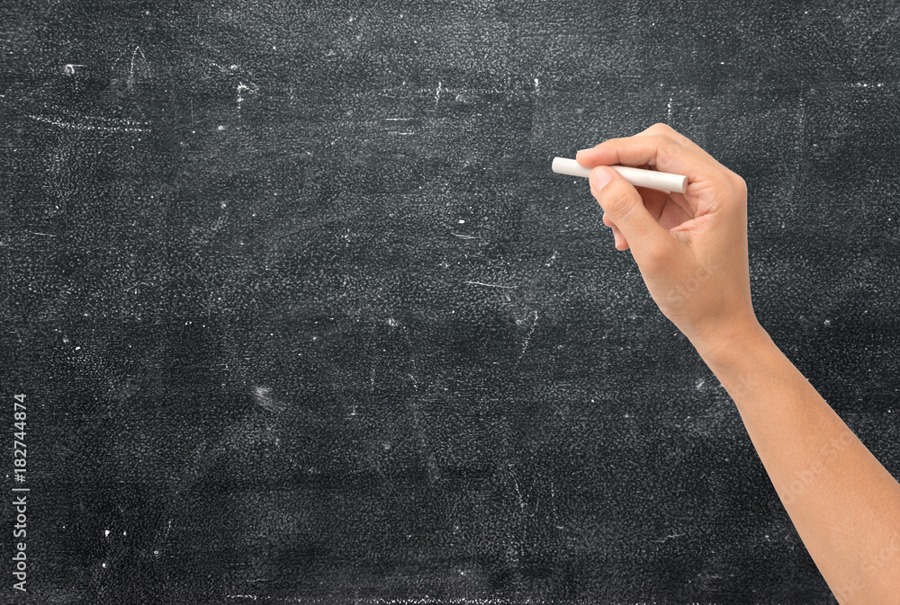 Hand holding white chalk and starting to write on blank chalkboard ...