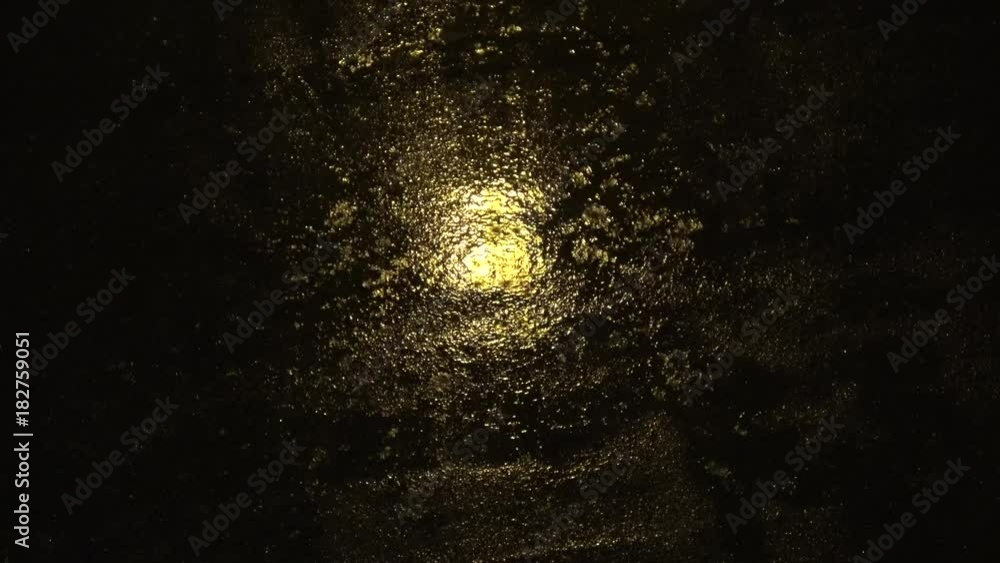 Top-down view of rainy street at night showing the dark paved road and ...