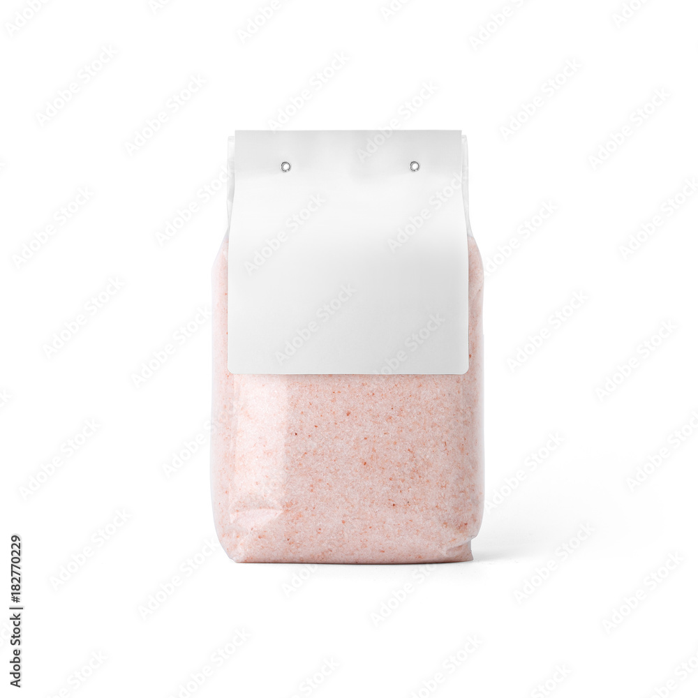 Pink salt in transparent plastic bag with white label isolated on white ...