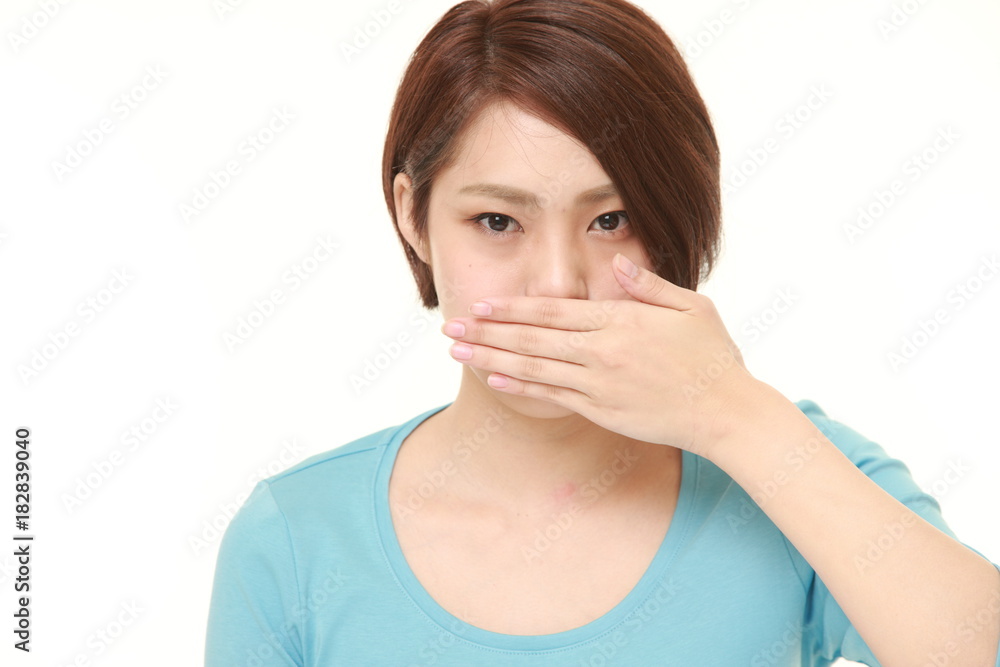 Japanese woman making the speak no evil gesture Stock Photo | Adobe Stock