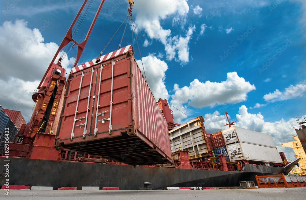Unit of container being load by the ship’s gears crane onto the ship ...