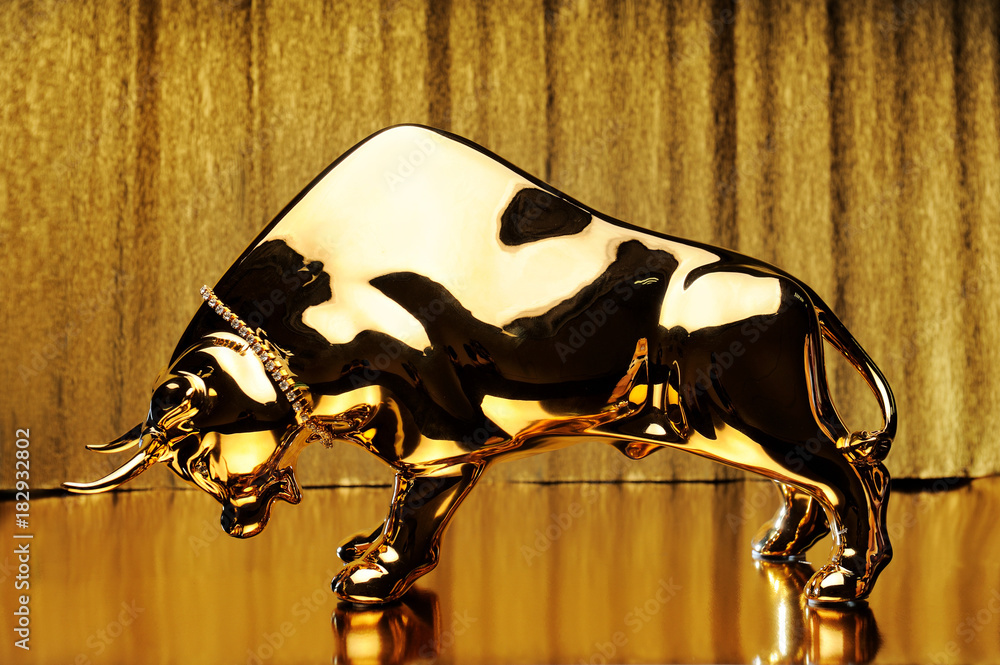 golden bull on a gold background Stock Photo | Adobe Stock
