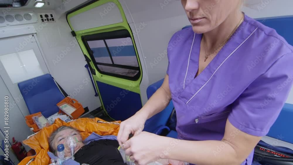 Emergency medical service. Paramedic caring for elderly patient in ...