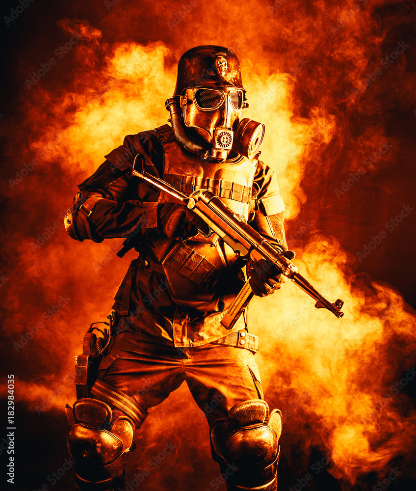 Futuristic soldier in fire and smoke gas mask and steel helmet with ...