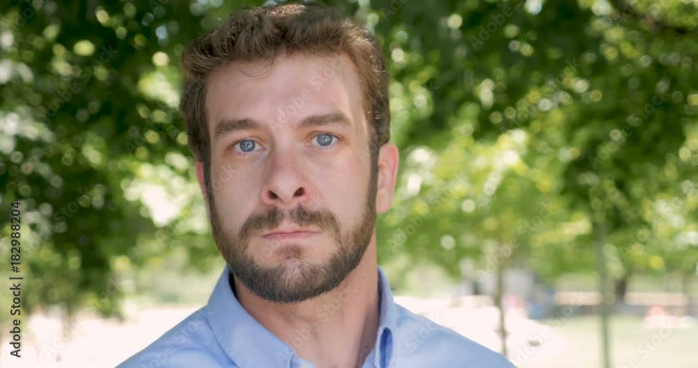 Very angry man pulls off his glasses and stares at the camera furious ...