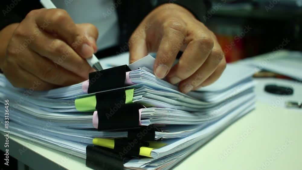 Businessman Preparing reports papers with graphs, charts on Stacks of ...