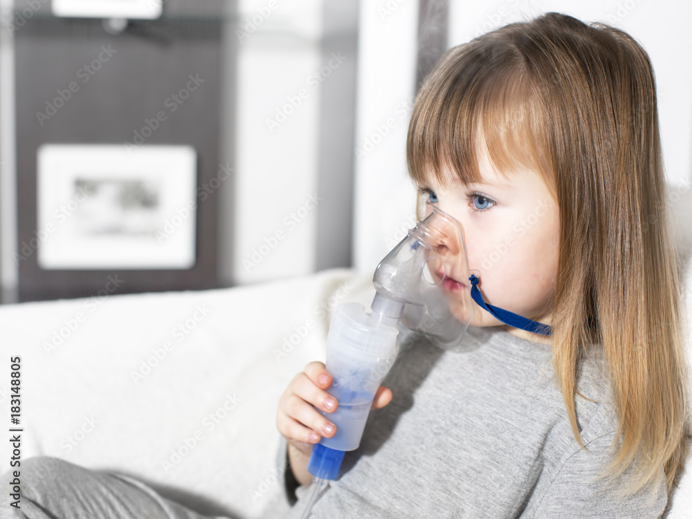 Little girl making inhalation with nebulizer at home. child asthma ...