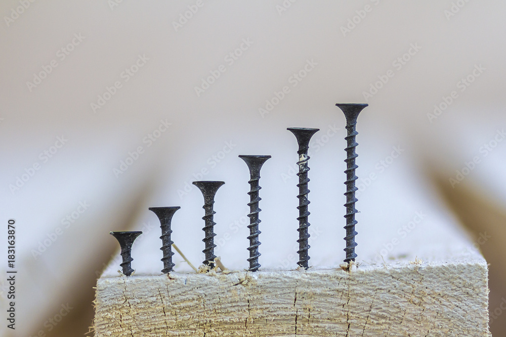 Positive graph made of screws as bar charts on board background Stock ...