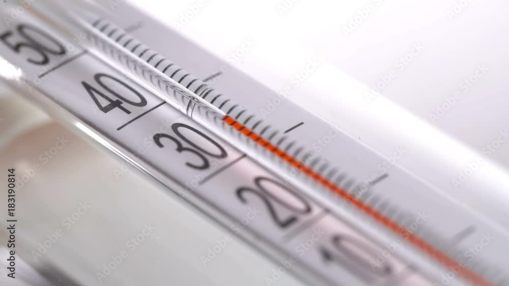 The red bar on the thermometer is slowly creeping up due to temperature ...