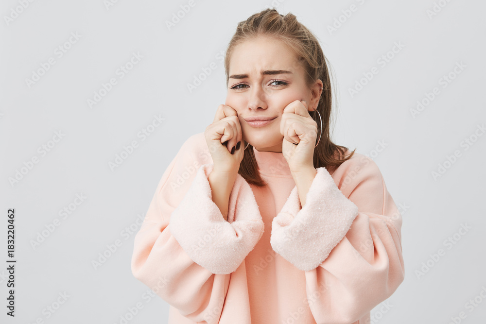 Isolated shot of pretty charming blonde caucasian girl in pink clothes ...