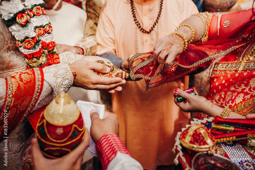 Hindu groom dressed in white sherwani embroidered with gold and perls ...