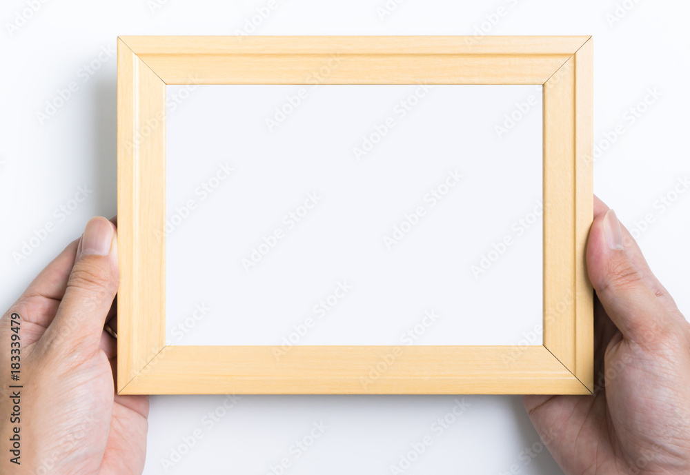 Hand holding empty photo frame for mock up Stock Photo | Adobe Stock